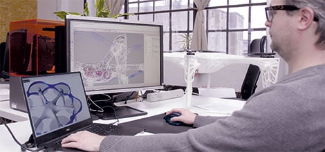 Pictured: Design engineer creating a custom 3D part using CAD software